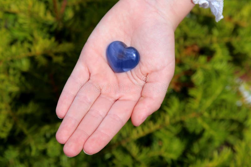 Blue Stone Heart in the Hands Stock Photo - Image of hand, holding ...