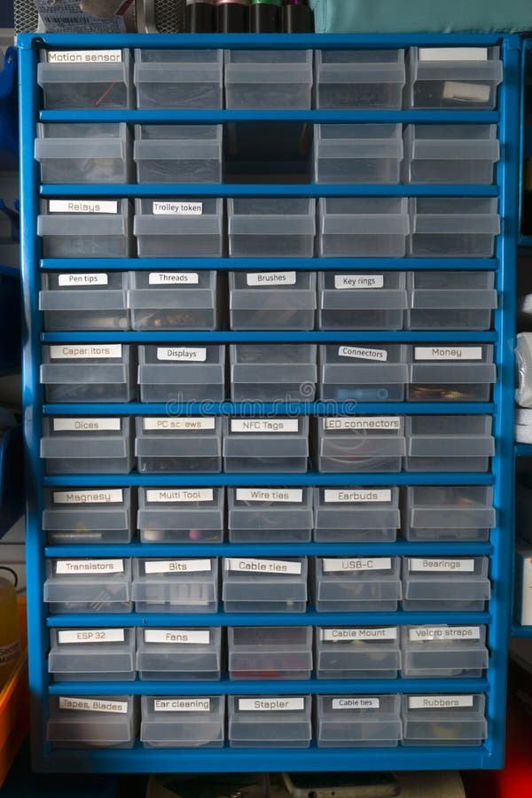 A Blue Storage Unit with Many Compartments and Labels Stock Image ...