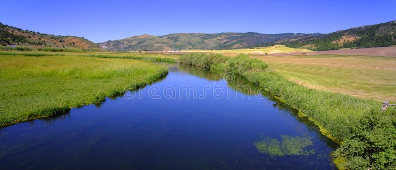 Blue Stream or River Flowing in Valley Reflecting Blue Sky and Clouds ...