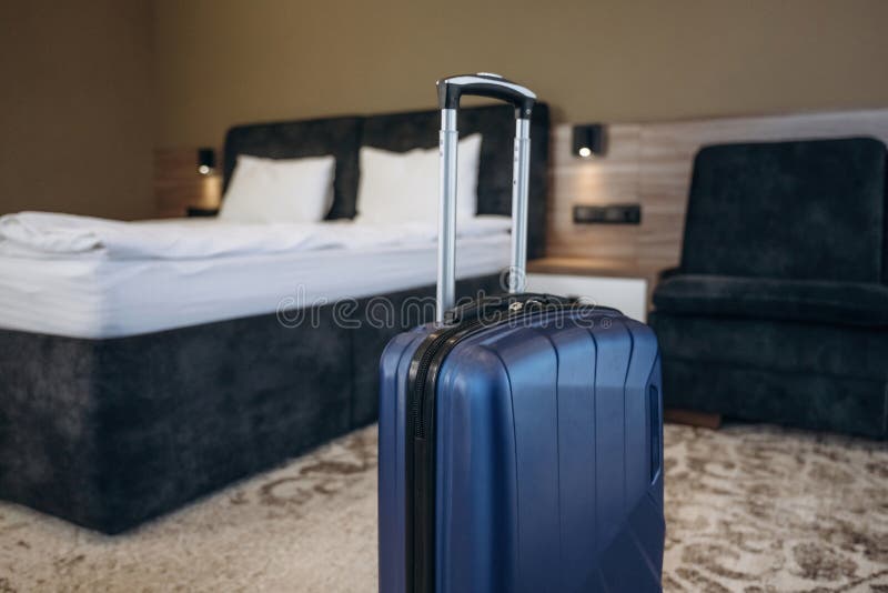 Blue Suitcase in the Modern Hotel Room Near the Bed Stock Image - Image ...