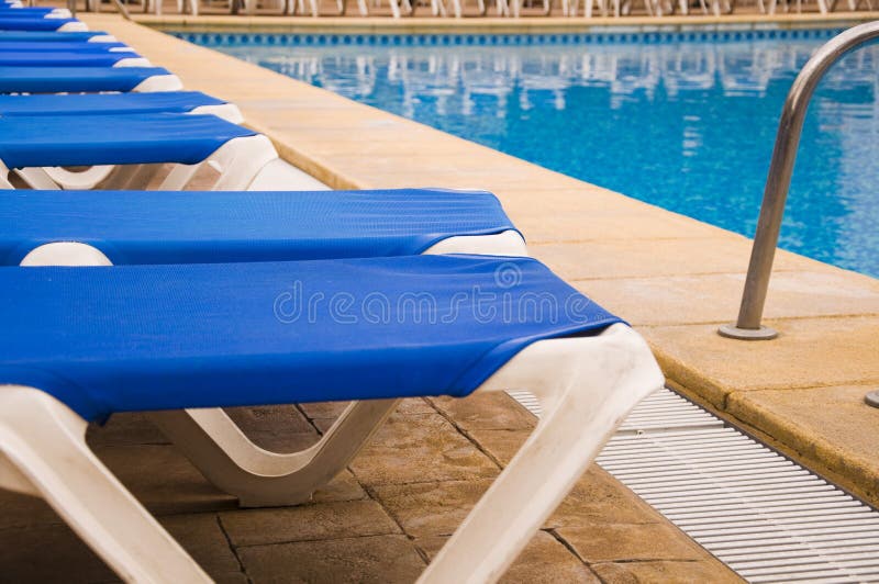Sunbeds in the Swimming Pool Stock Photo - Image of chair, blue: 30212544