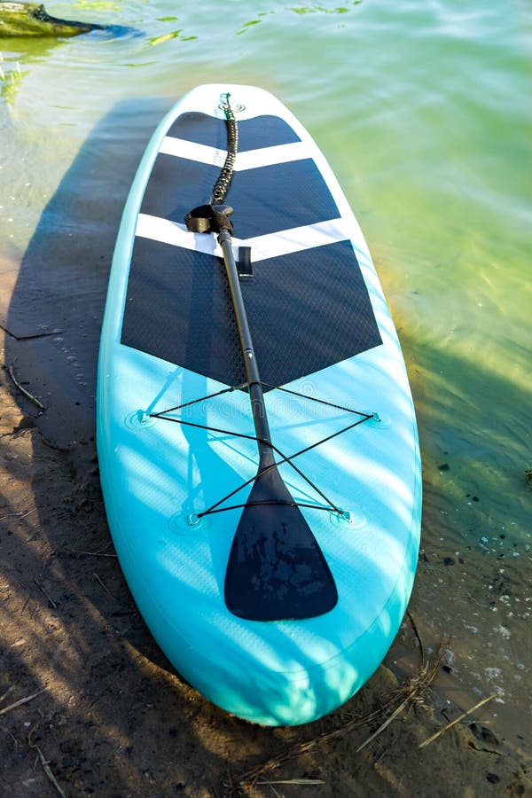 Blue Sup Board with Paddle Near the Shore Stock Image - Image of sail ...