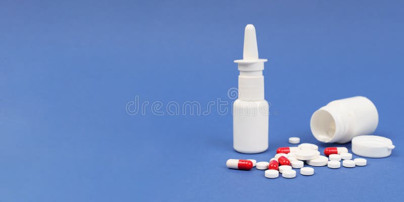 On a Blue Surface are White Tablets and Red-white Capsules, an Open ...