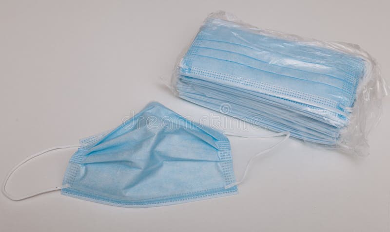 Blue Surgical Masks in a White Table Stock Photo - Image of nose, masks ...