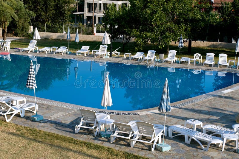 Blue swiming pool stock image. Image of landscape, chairs - 4787489