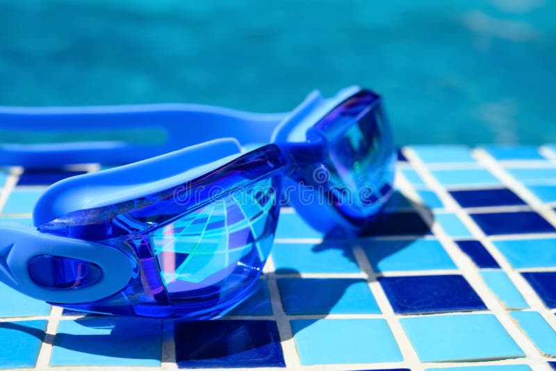 A Blue Swimming Goggles on the Side of a Swimming Pool Stock Image ...