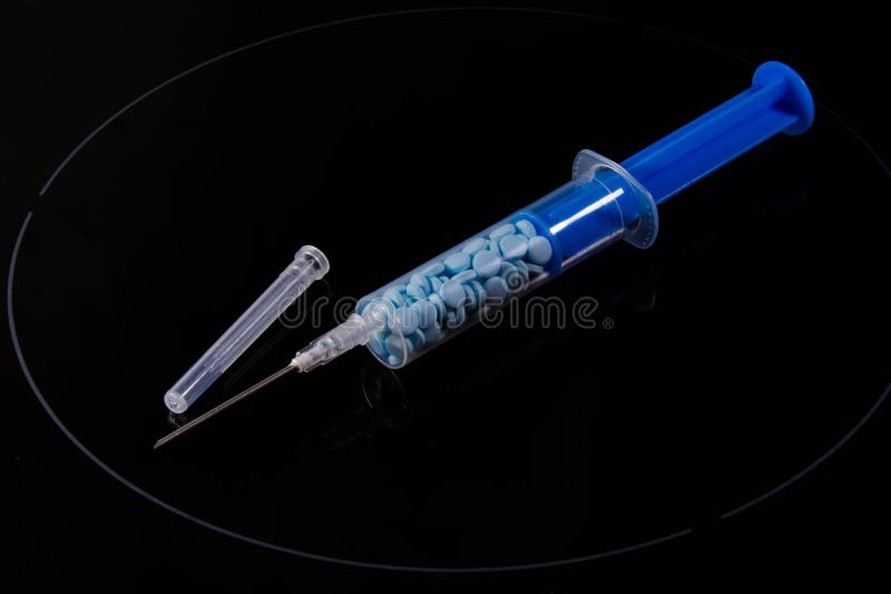 Blue Syringe Filled with Blue Mini Tablets. Stock Image - Image of ...