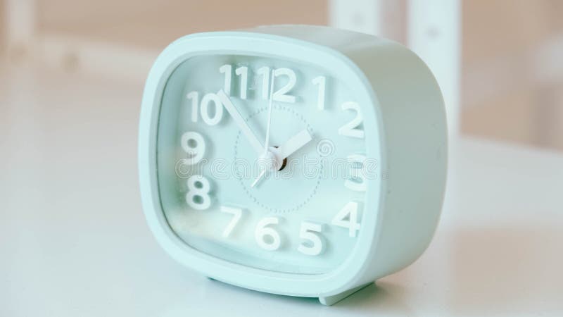Blue Table Clock with Arrows on a White Table Stock Image - Image of ...