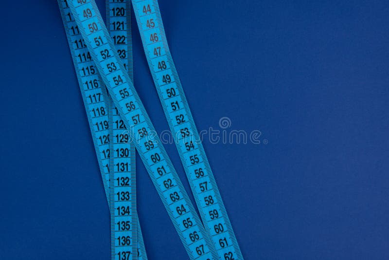 Blue Tape Measure on the Bright Blue Background Stock Image - Image of ...