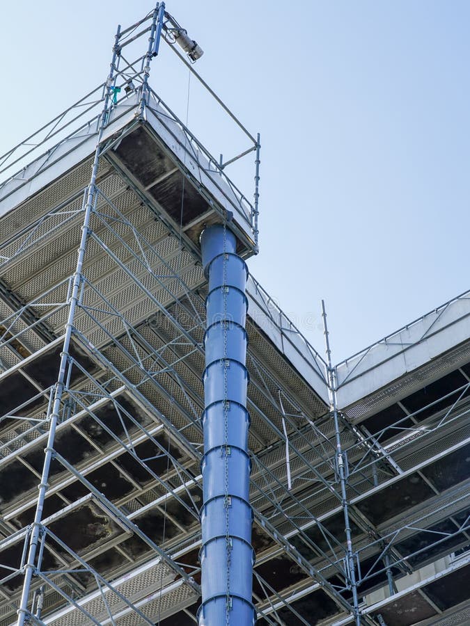Blue Plastic Construction Debris Pipe and Scaffolding at Building ...
