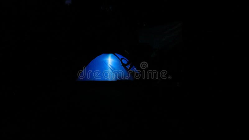 Blue Tent Illuminated from the Inside at Night in a Forest Glade. Stock ...