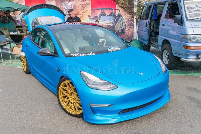 A Blue Tesla Model S Electric Car is Showcased from Its Front and Side ...