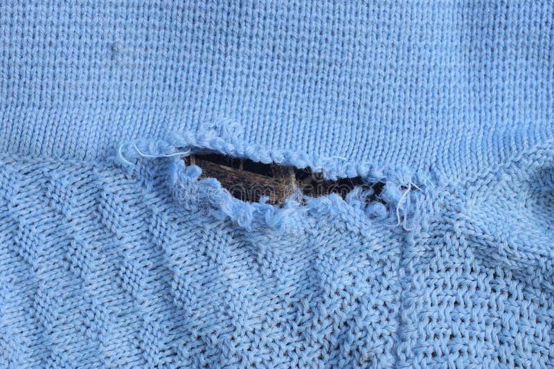Blue Texture of Woolen Torn Fabric with a Black Hole Stock Photo ...
