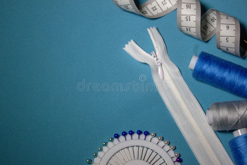 Sewing Accessories and Fabric on a Blue Background. Sewing Threads ...