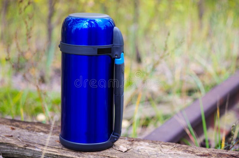 A Blue Thermos for Saving Hot Drinks. Thermos on the Left. Autumn ...