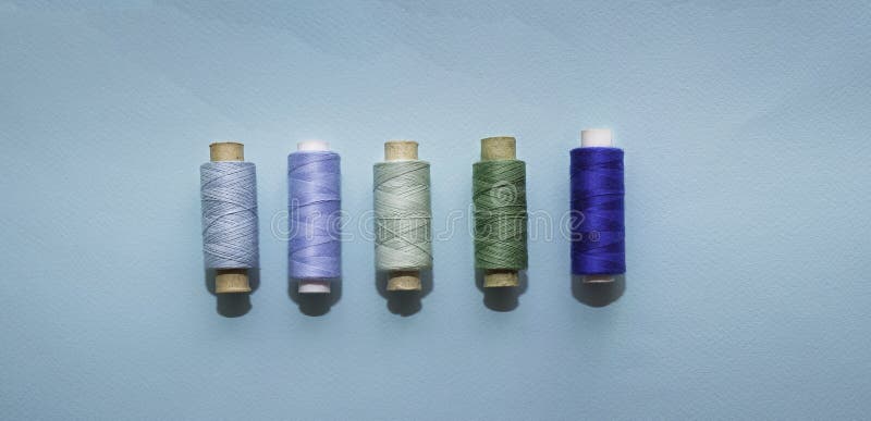 Blue Thread Reels for Sewing on a Blue Background. Concept of Blue ...