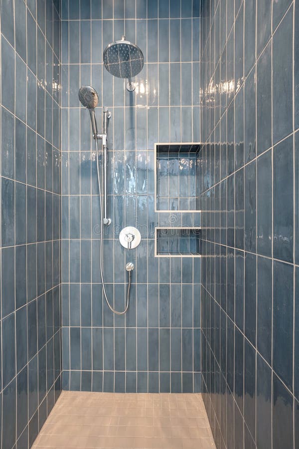 A Blue Tiled Shower with a Silver Shower Head Stock Image - Image of ...