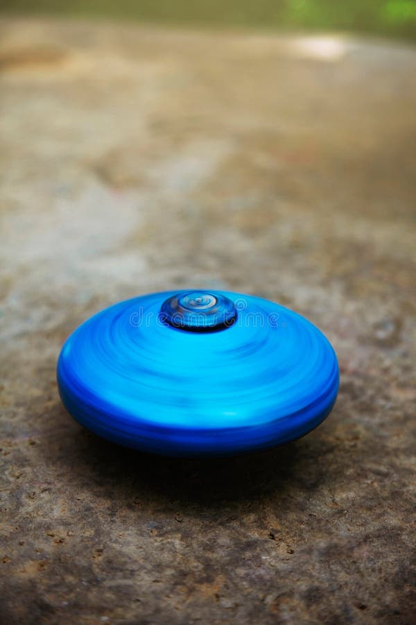 Blue Top Spinning on the Ground Stock Image - Image of compound, talent ...