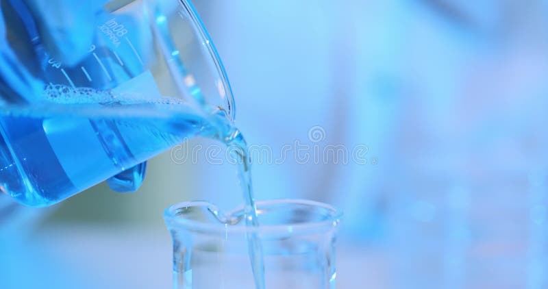 Blue Toxic Liquid is Poured into a Flask in a Laboratory Stock Footage ...