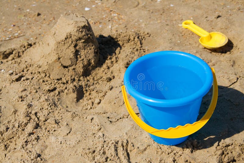 Blue Toy Bucket and Yellow Spade Stock Image - Image of pail, yellow ...