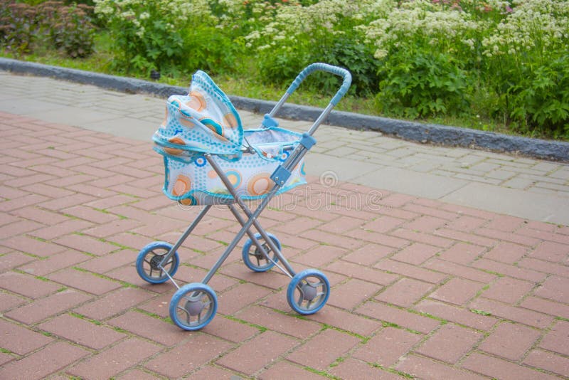 Blue Toy Stroller for Doll Left on Road Stock Photo - Image of play ...
