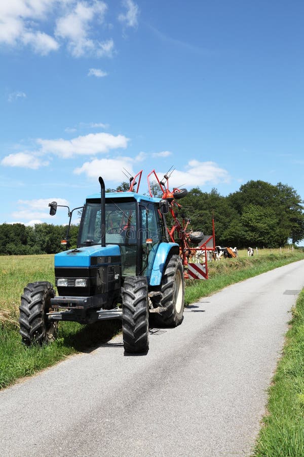 Blue Tractor and Hay Rake Summer Road Stock Photo - Image of farm ...