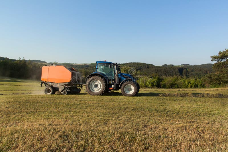 Blue Tractor on the Pasture.. Agricultural Work on the Farm in the ...