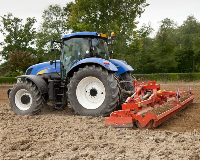Blue Tractor Pulling Power Harrow Stock Photo - Image of power ...