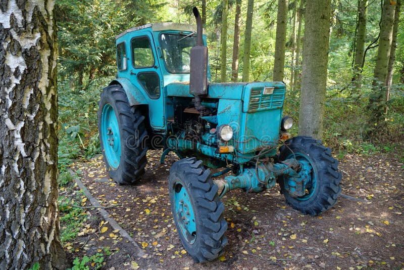 Blue Tractor Stands in the Forest Stock Photo - Image of blue ...