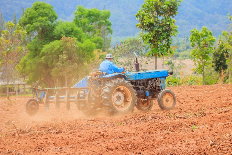 Blue Tractor Work on the Field. Editorial Stock Photo - Image of blue ...