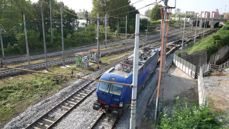 Blue Train on Railway Tracks with Urban Backdrop Stock Video - Video of ...