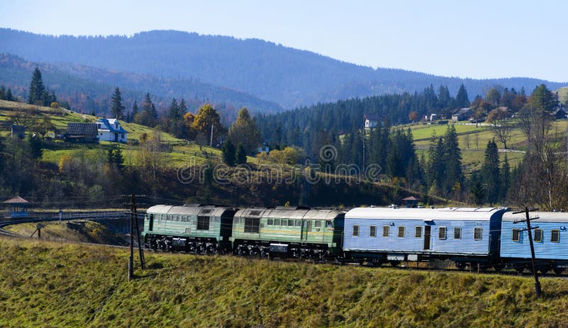 Blue Train Running through Green Carpathians Mountains Stock Photo ...