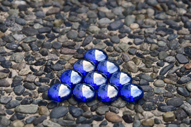 Blue Triangle on Pebblestone Background Stock Image - Image of ...