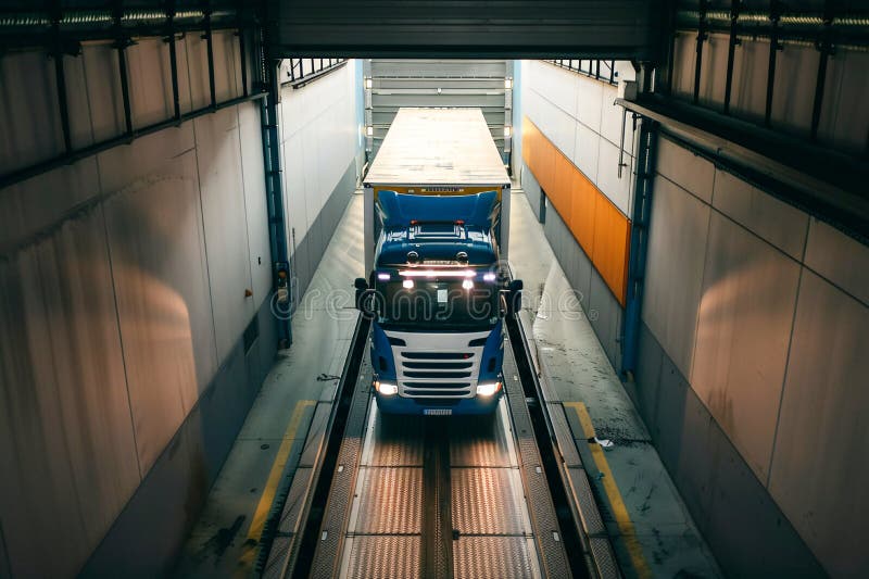 Blue Truck with a Container Trailer Inside a Narrow, Industrial Loading ...