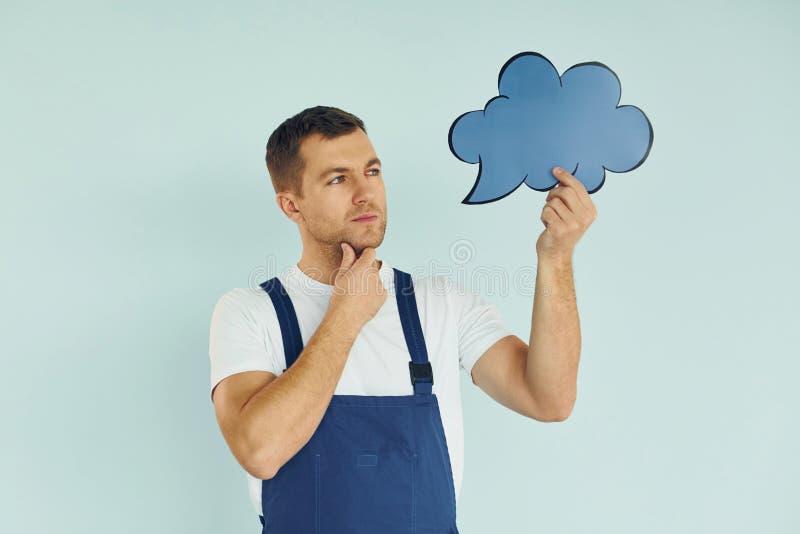 In Blue Uniform. Man Standing in the Studio with Empty Signs for the ...