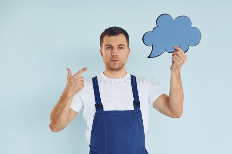 In Blue Uniform. Man Standing in the Studio with Empty Signs for the ...