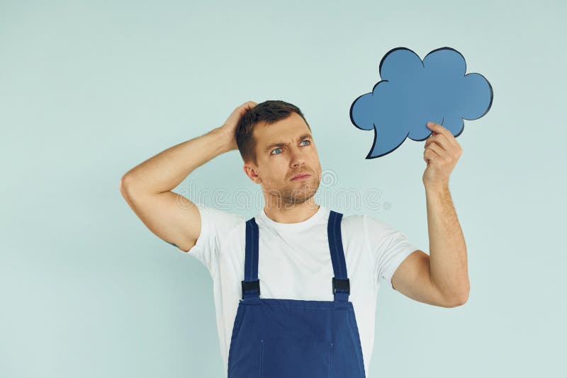 In Blue Uniform. Man Standing in the Studio with Empty Signs for the ...