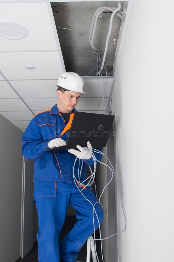 A Blue-uniformed Master Wiring a WiFi Router in a Hidden False Ceiling ...