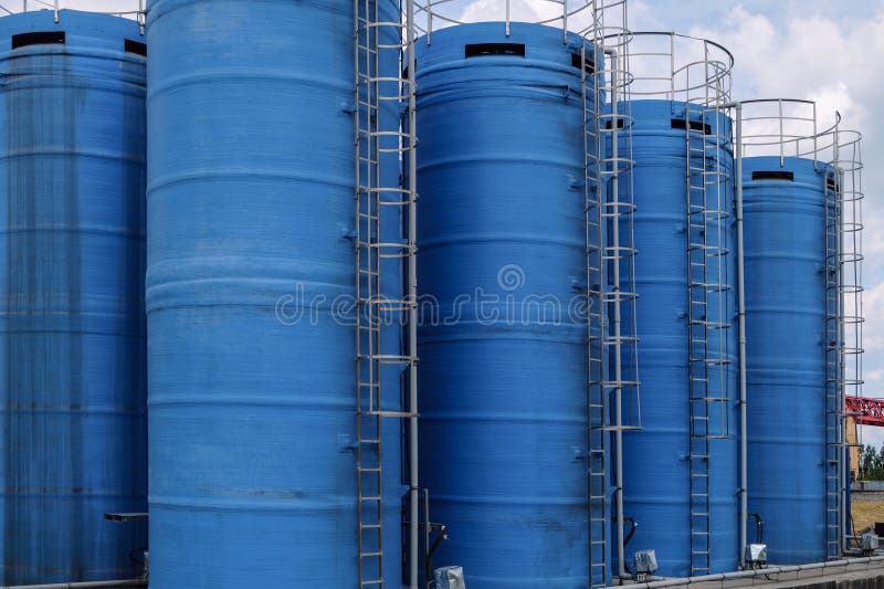 Blue Vertical Liquid Chemical Storage Tanks with Ladders Stock Image ...