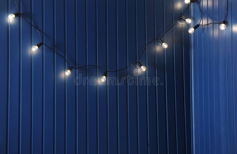 Blue Wall with Retro Garland of Light Bulbs. Texture for the Design ...