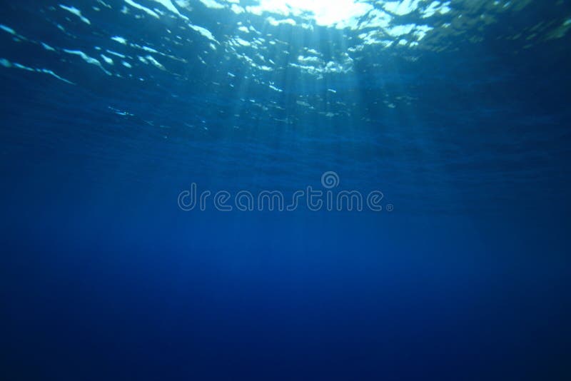 Sun rays in blue water stock photo. Image of texture - 15075914