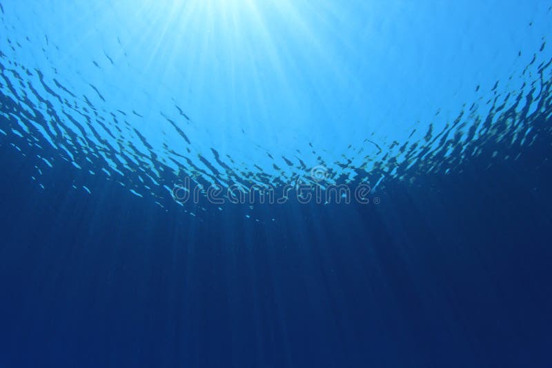Sun rays in blue water stock photo. Image of texture - 15075914