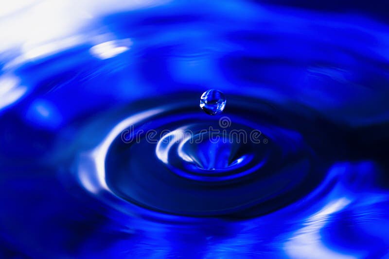 Drop of Water Falling in Blue Water and Blue Background. Stock Photo ...