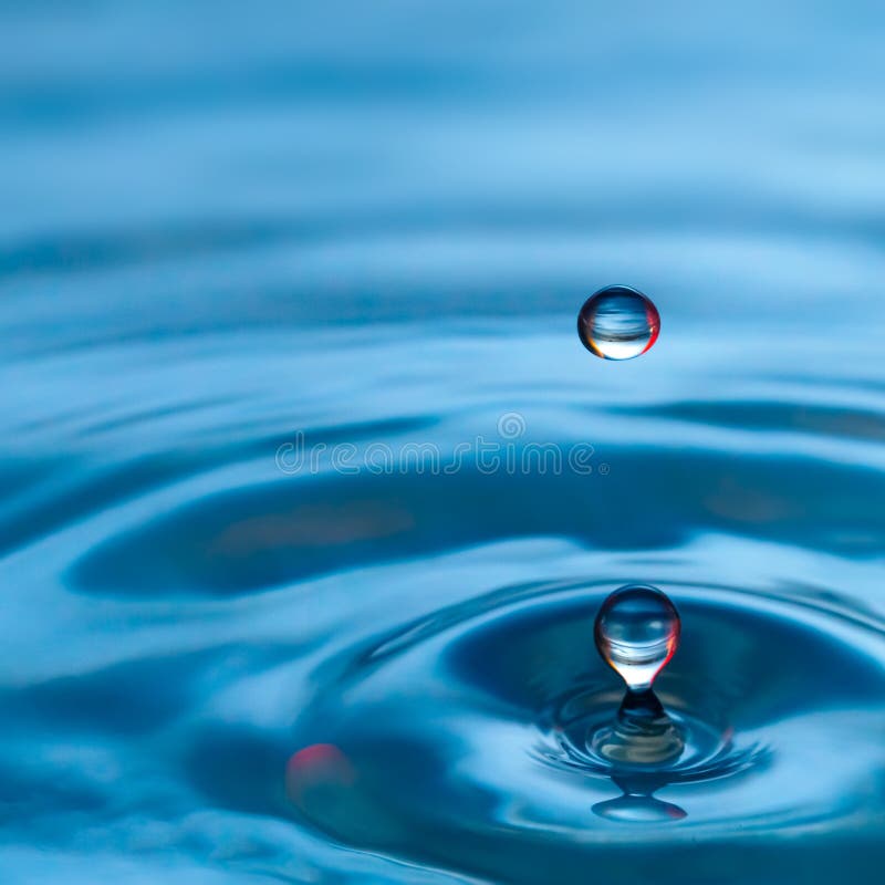 Blue Water Drop Splash with Red Tones Stock Photo - Image of ripple ...