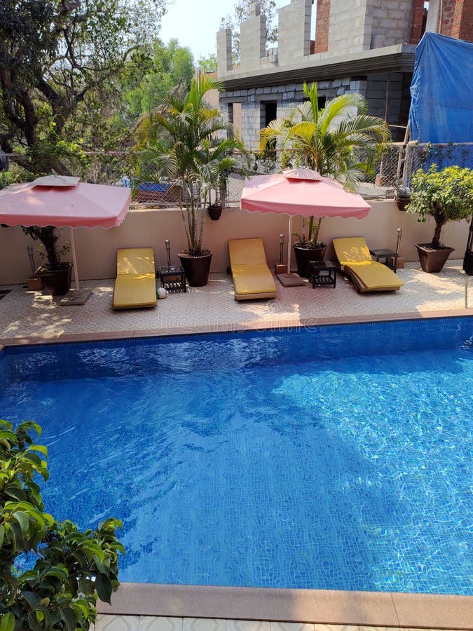 Blue water pool goa hotel stock image. Image of hotel - 176395181