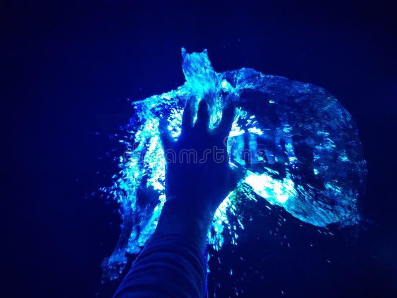 Blue Water Splash and Hand on Dark Background Stock Image - Image of ...