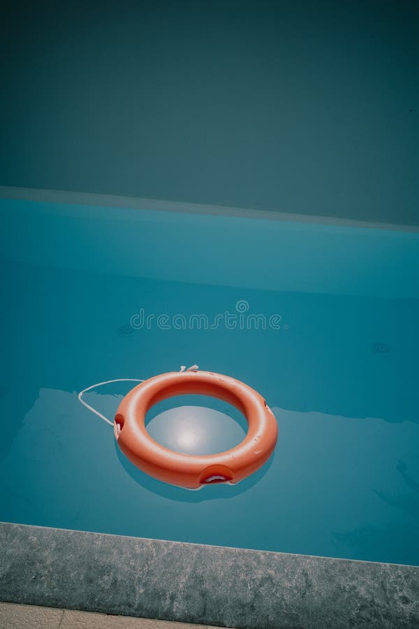 In the Blue Water of a Swimming Pool Floats One Red Life Ring Stock ...