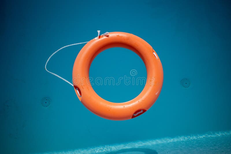 In the Blue Water of a Swimming Pool Floats One Red Life Ring Stock ...