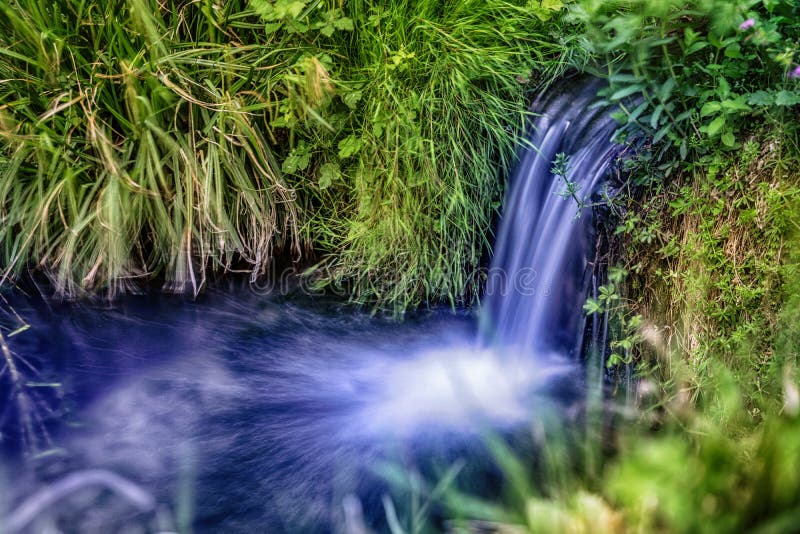 Blue Waterfall among Green Grass Stock Photo - Image of exposure, soft ...