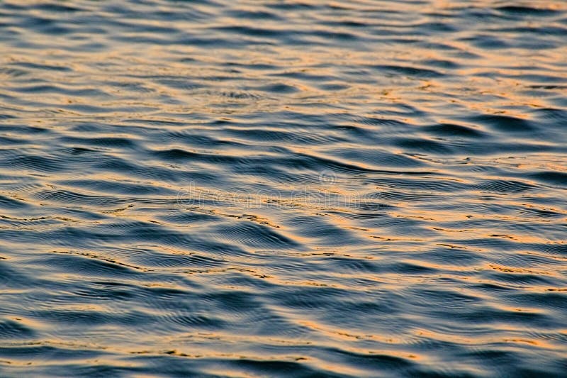 Rippling Water with Reflections of the Evening Sun Stock Image - Image ...